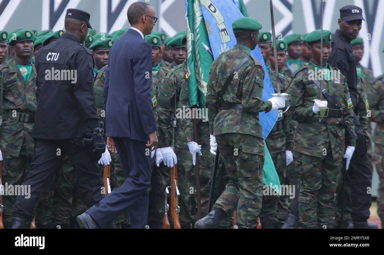 President Paul Kagame, middle, inspect guard of honor during swearing ...