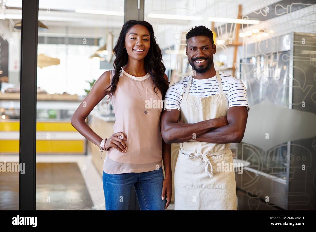 Proud of their little coffee shop. Portrait of two coffee shop owners ...