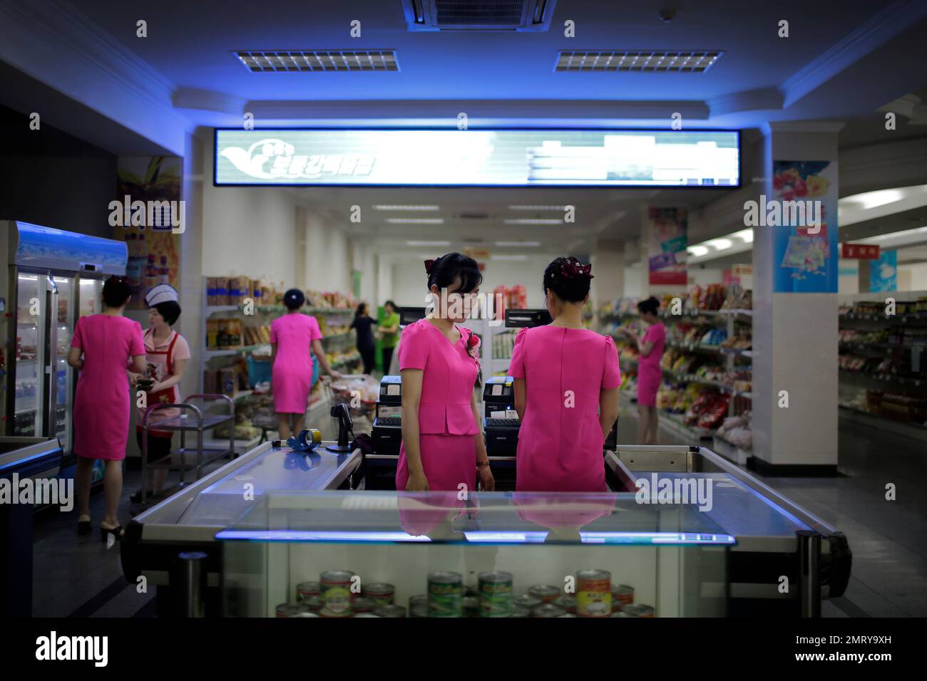 In this Monday, June 19, 2017, photo, cashiers stand at their stations ...