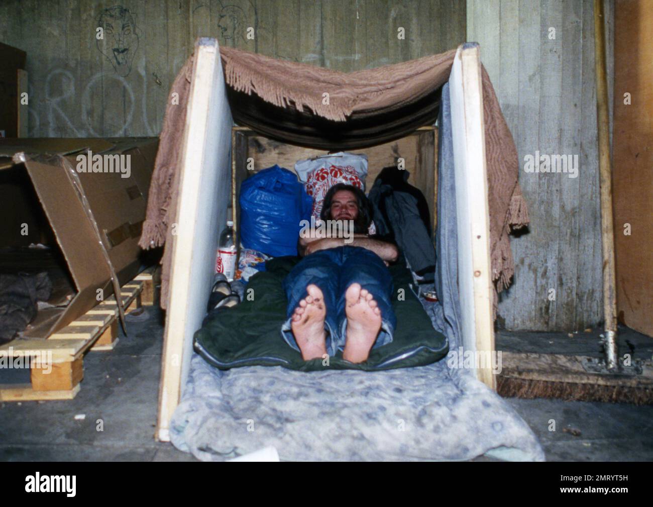 A homeless man sleeps in his makeshift cardboard home under London's ...
