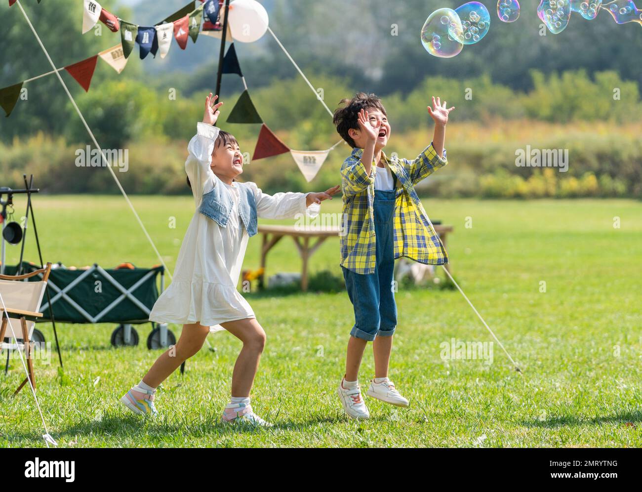 Two children playing on the grass Stock Photo - Alamy