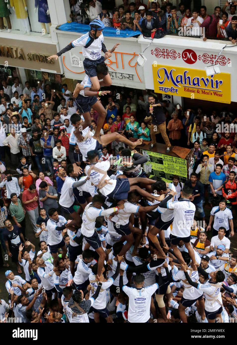 Indian youth collapse as they try to form a human pyramid to break the ...