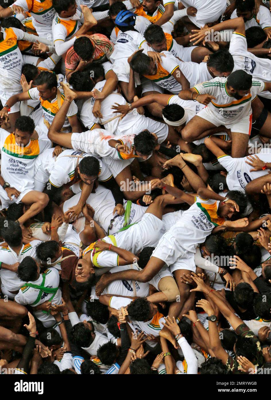 Indian youth collapse as they try to form a human pyramid to break the ...