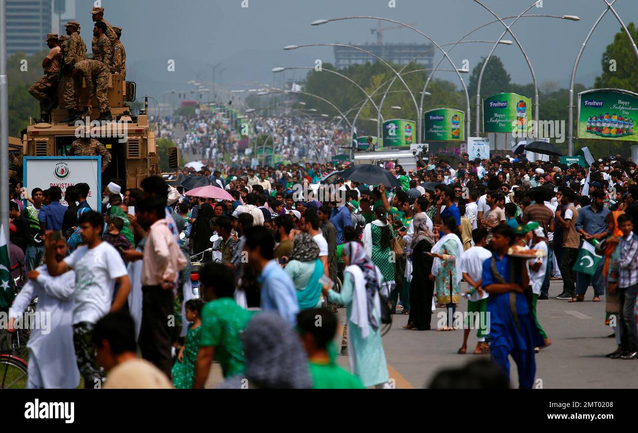 People arrives to watch Pakistan Air Force fighter jets during an air ...