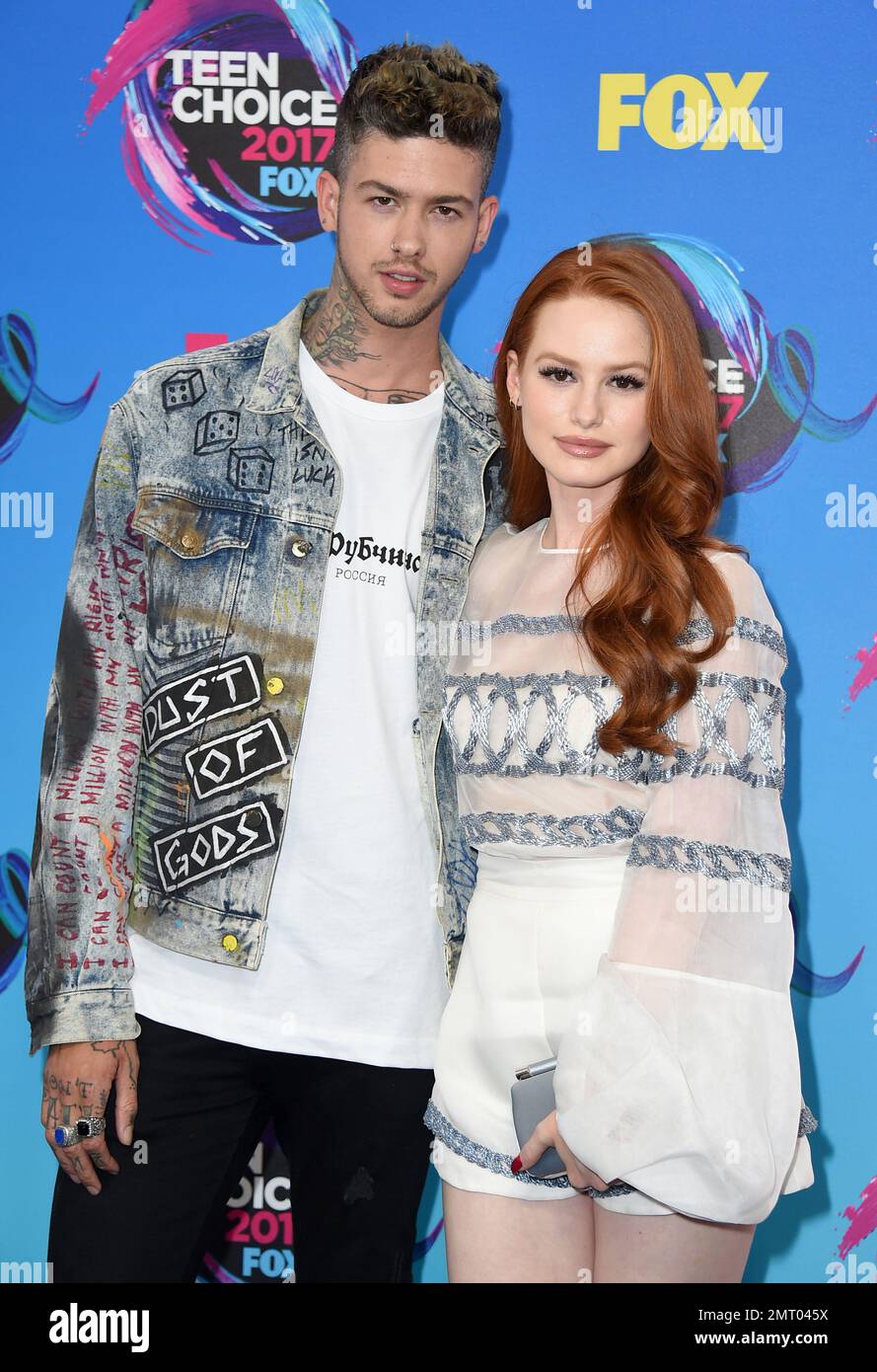 Travis Mills, left, and Madelaine Petsch arrive at the Teen Choice ...