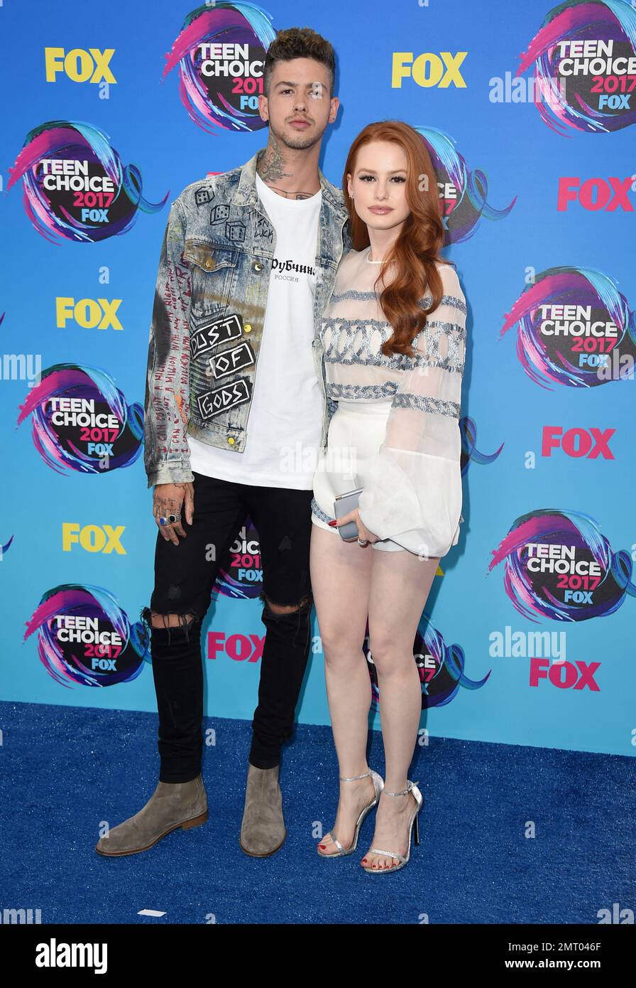 Travis Mills, left, and Madelaine Petsch arrive at the Teen Choice ...
