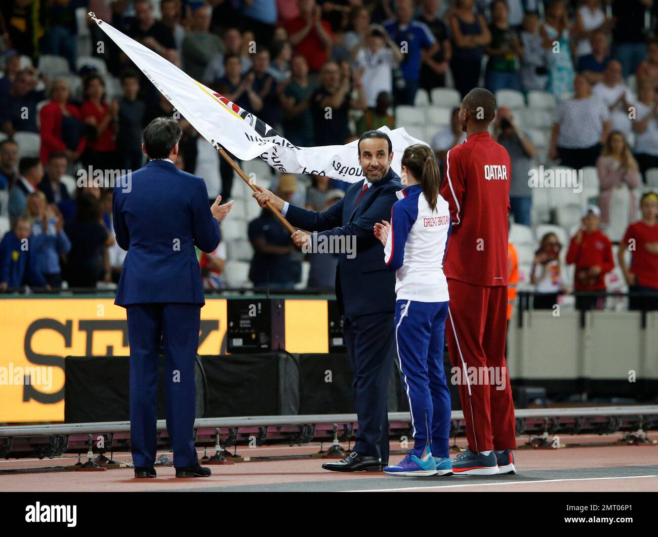 IAAF President Sebastian Coe, left, hands over the IAAF flag to Qatar ...