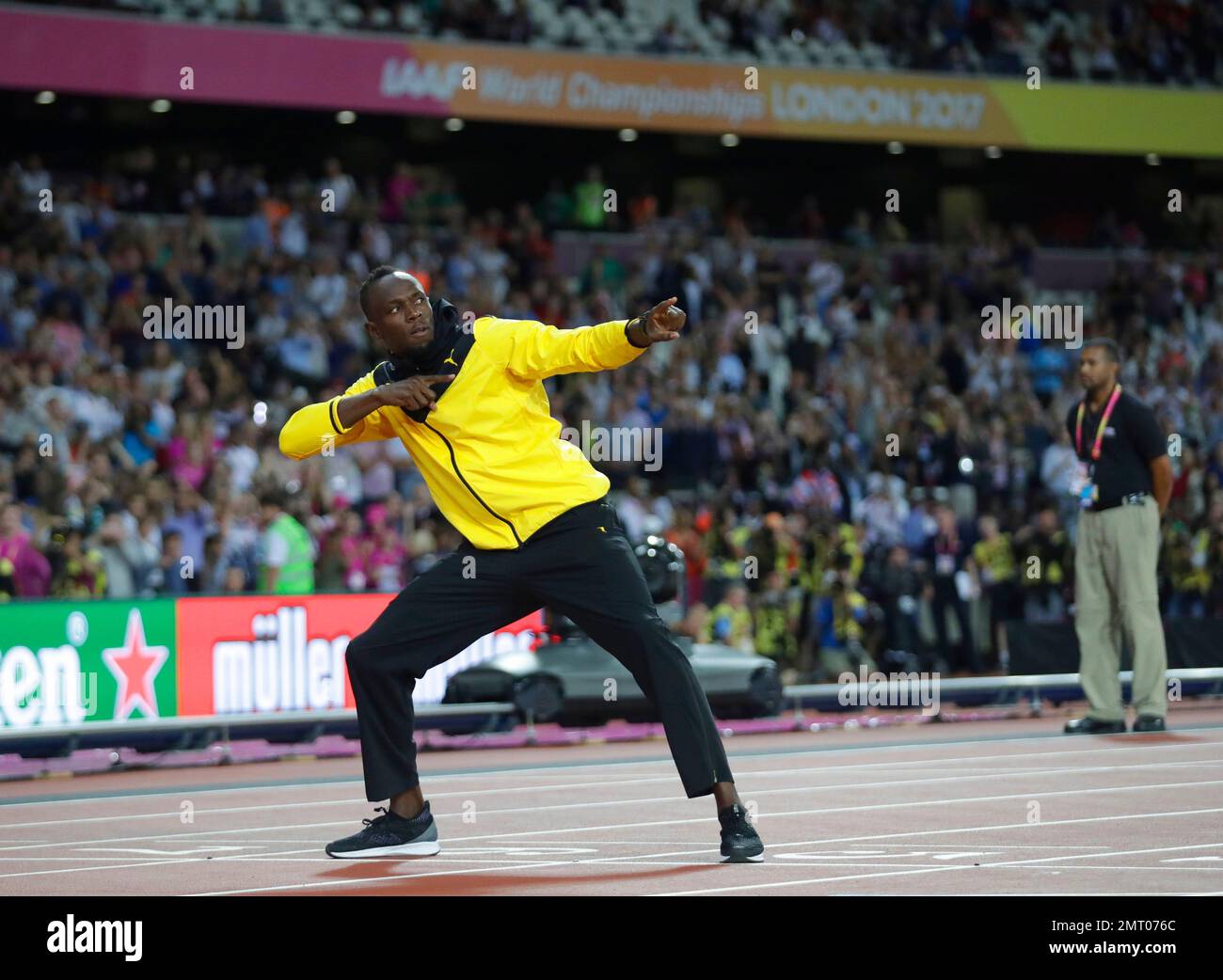 Jamaica's Usain Bolt makes his trademark gesture during a lap of honor ...