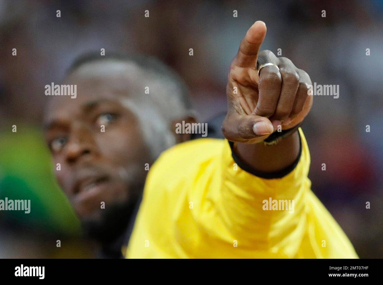 Jamaica's Usain Bolt makes his trademark gesture during a lap of honor ...