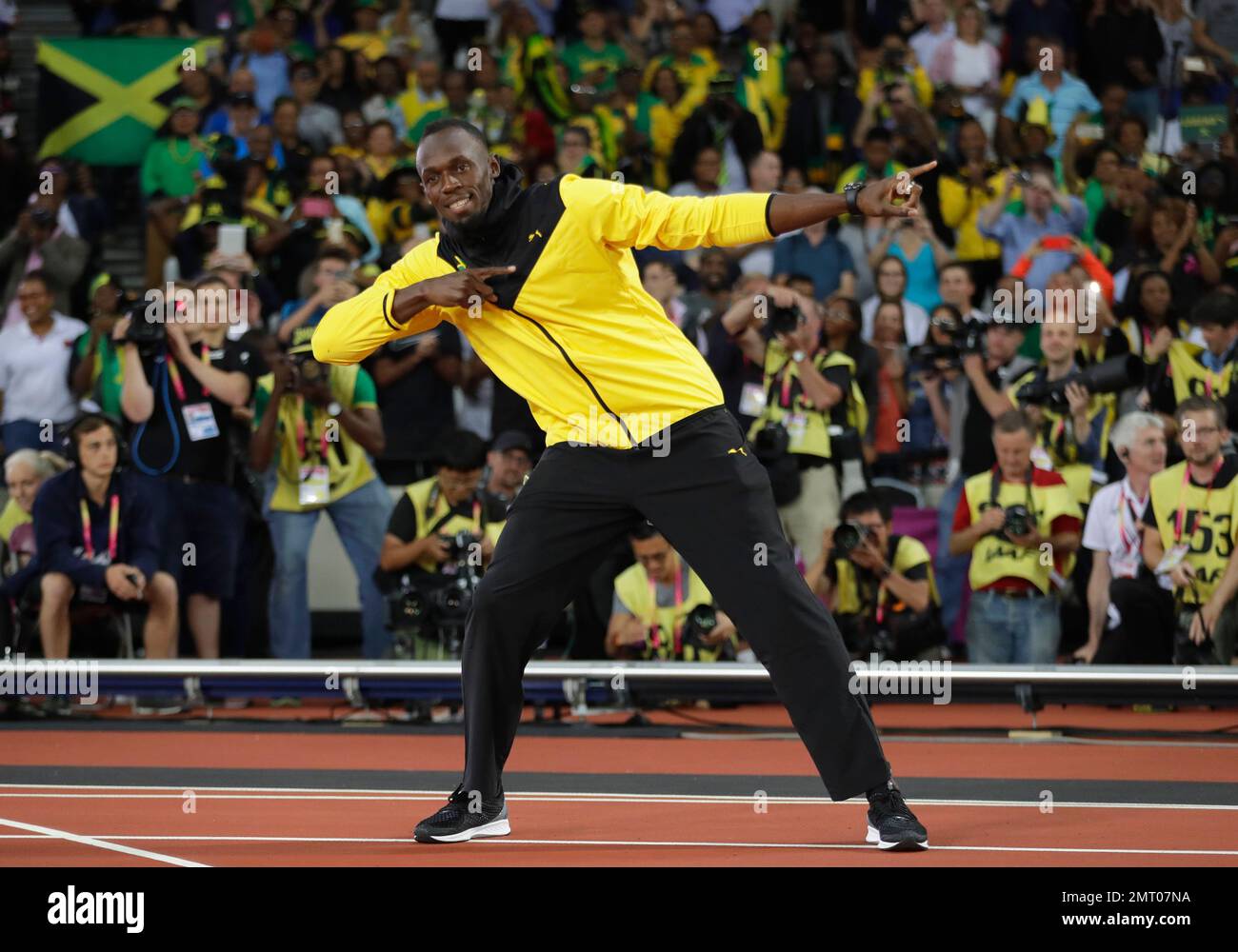 Jamaica's Usain Bolt makes his trademark gesture during a lap of honor ...