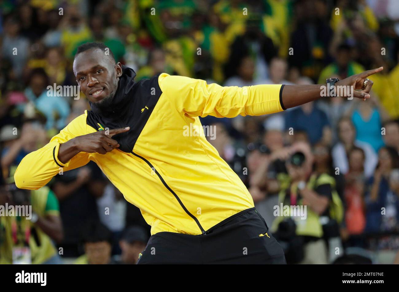 Jamaica's Usain Bolt makes his trademark gesture during a lap of honor ...