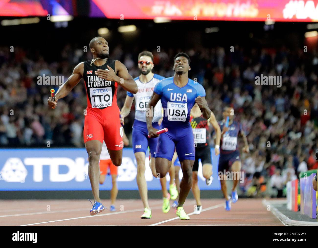 Trinidad and Tobago's Lalonde Gordon, left, races anchor leg to win the ...