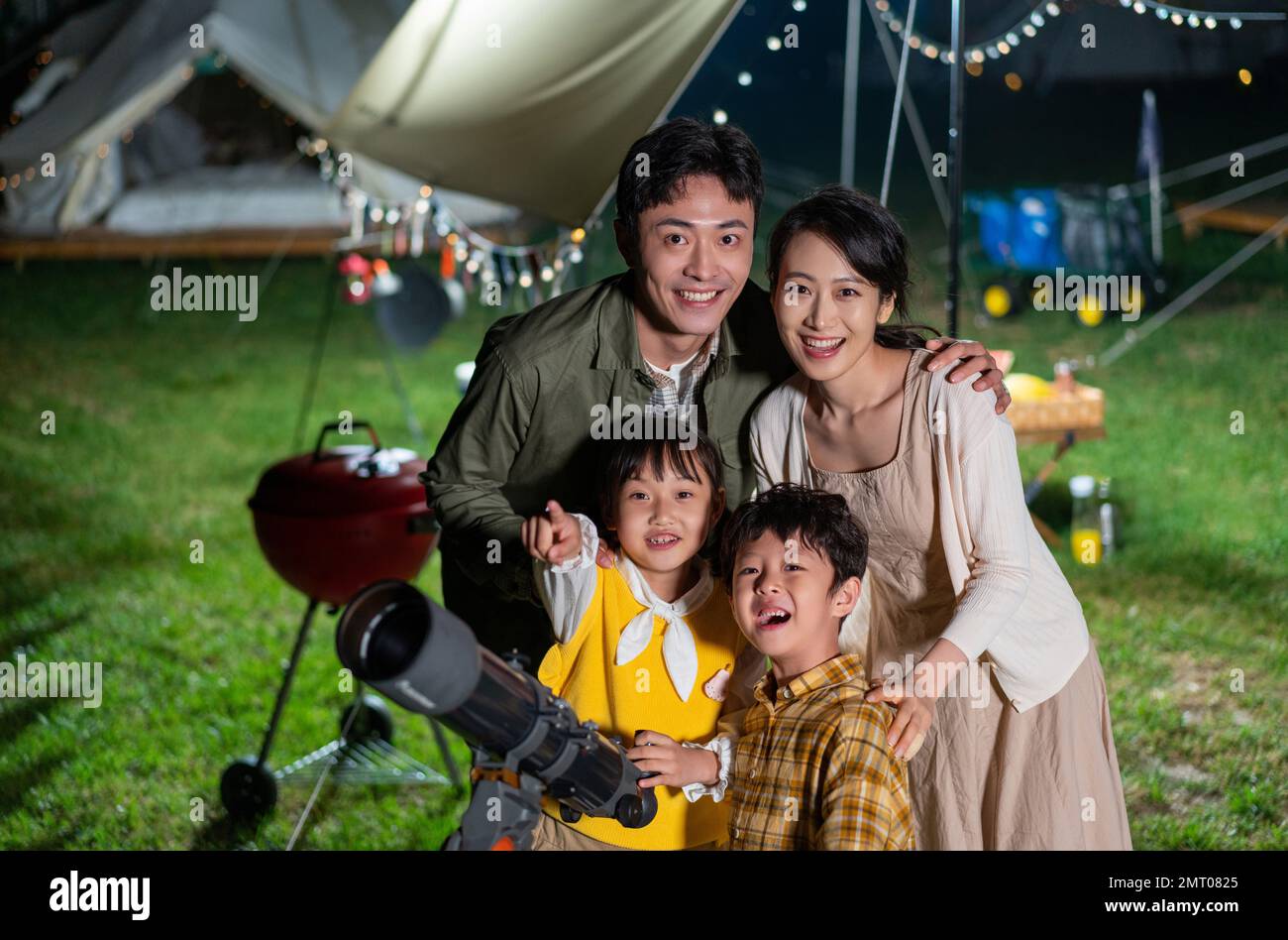 In the evening the family in the camp to use a telescope to see the ...