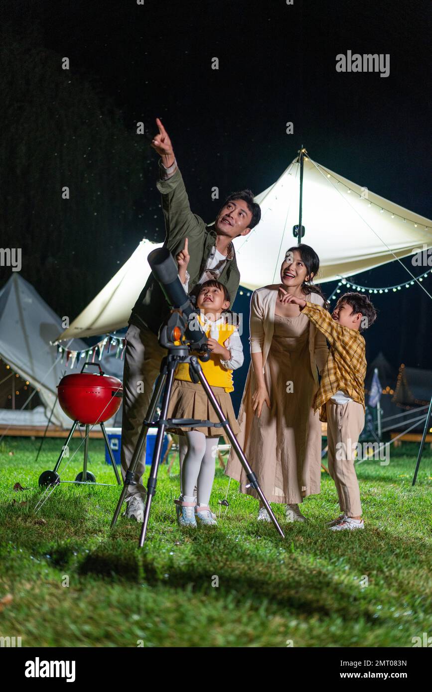 In the evening the family in the camp to use a telescope to see the ...