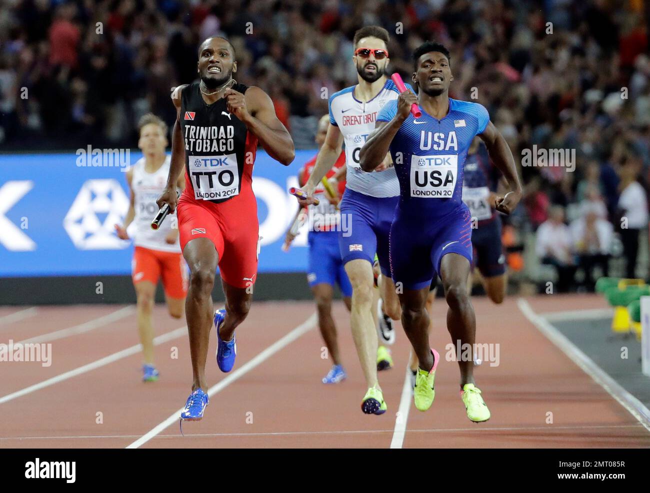 Trinidad and Tobago's Lalonde Gordon, left, races anchor leg to win the ...