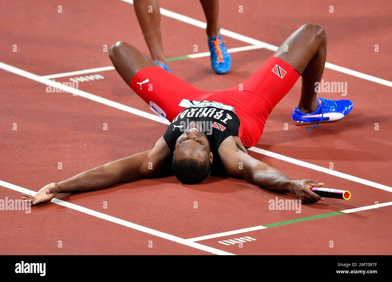 Trinidad and Tobago's Lalonde Gordon lies on the track as he celebrates ...