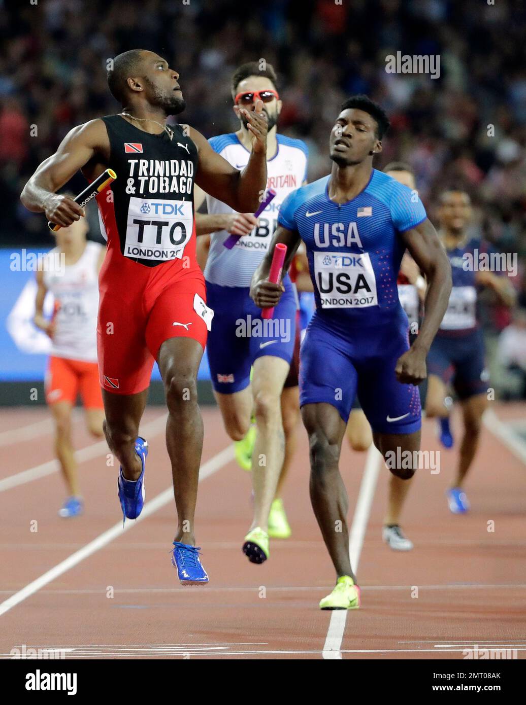 Trinidad and Tobago's Lalonde Gordon, left, races the anchor leg to win ...