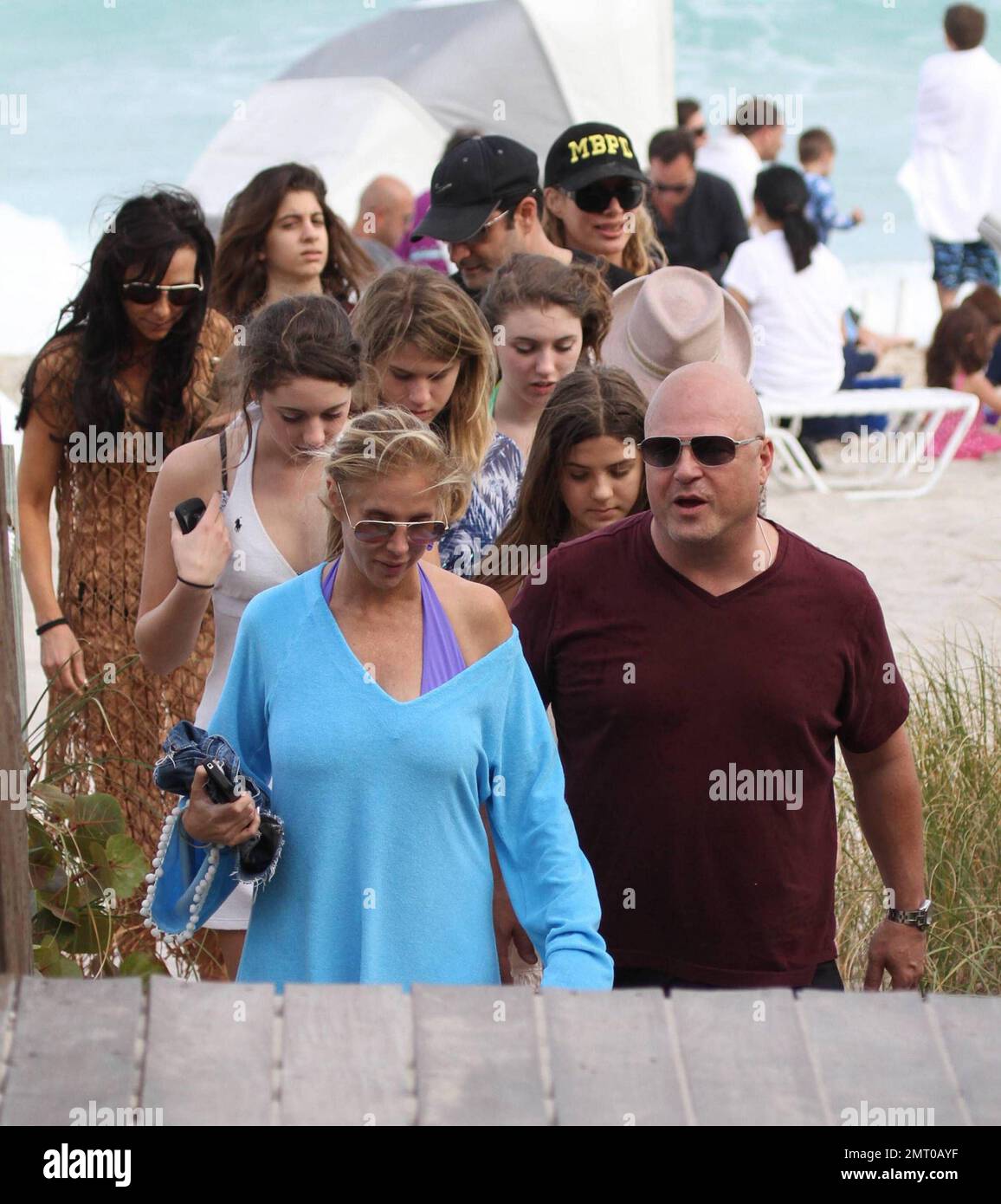 Maria Menounos and Michael Chiklis fool around on the beach following a ...