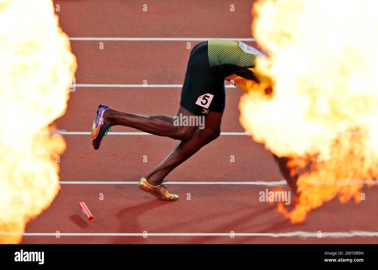 Fireworks for the winner goes off as Jamaica's Usain Bolt falls after ...