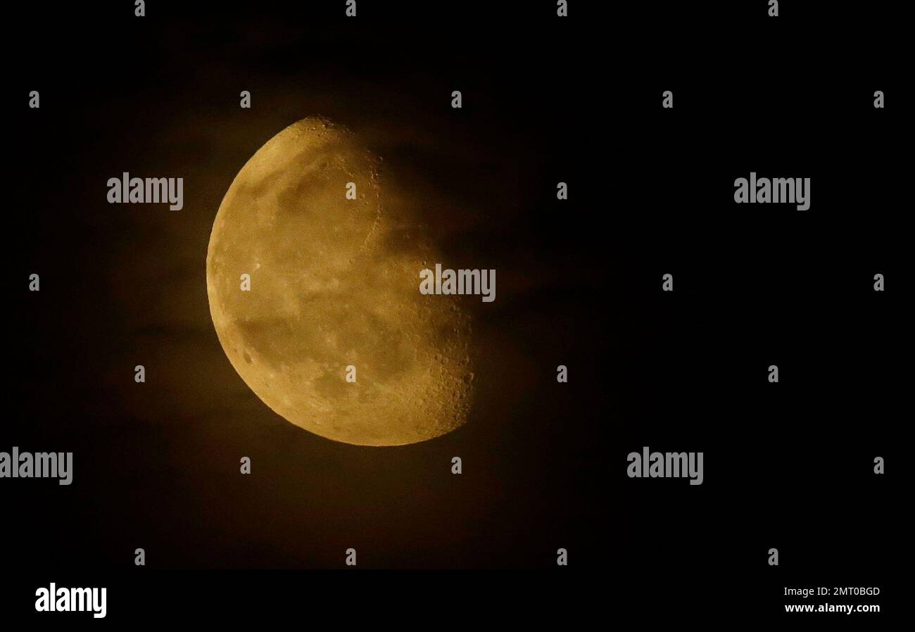 Smoke from nearby wildfires makes the moon appear yellow as viewed near ...