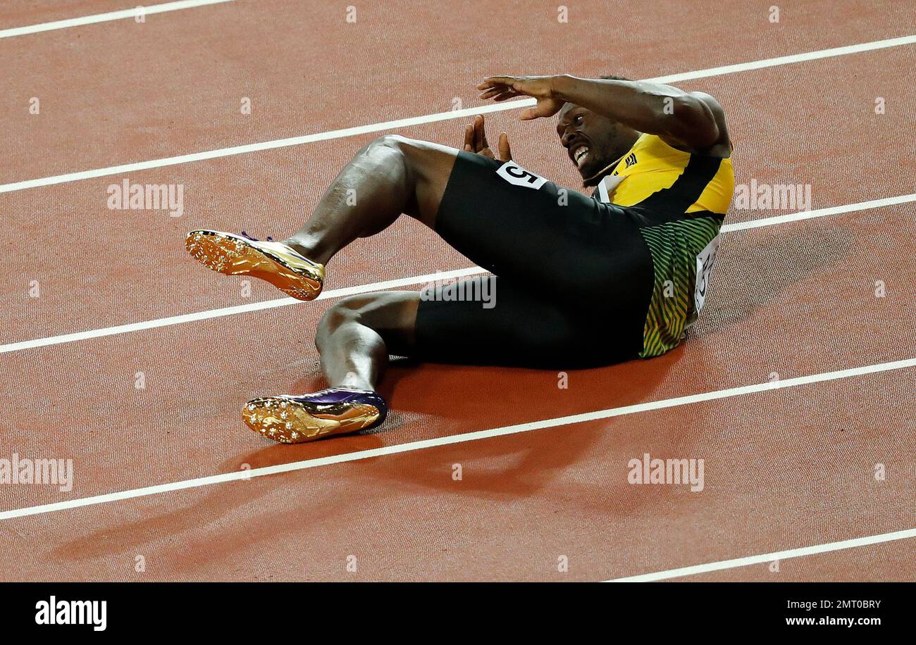 Jamaica's Usain Bolt falls after suffering an injury in the men's 4x100 ...