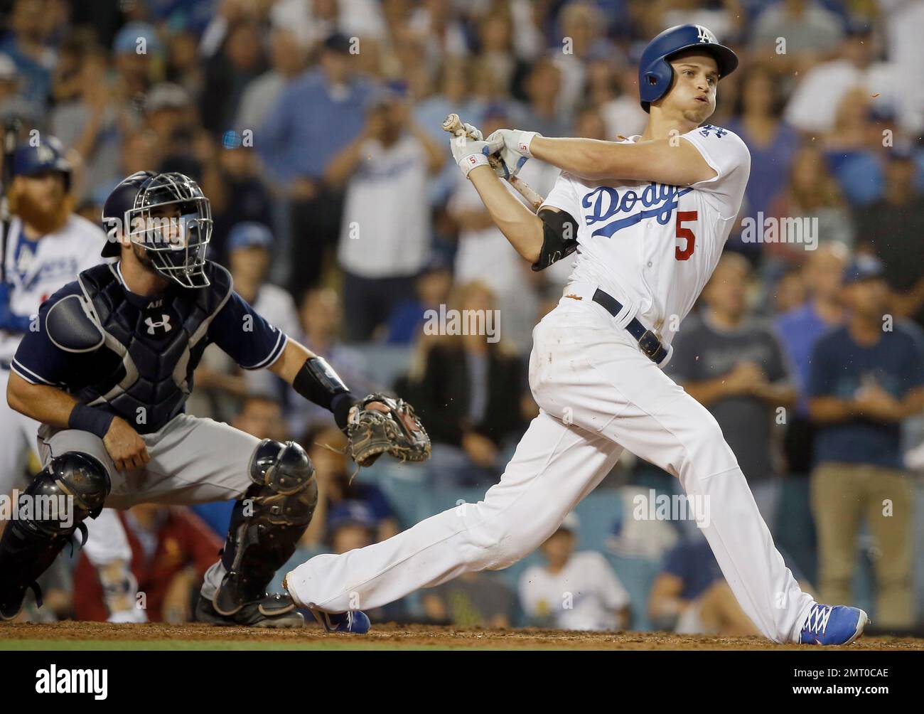 Los Angeles Dodgers' Corey Seager follows through on a three-run single ...