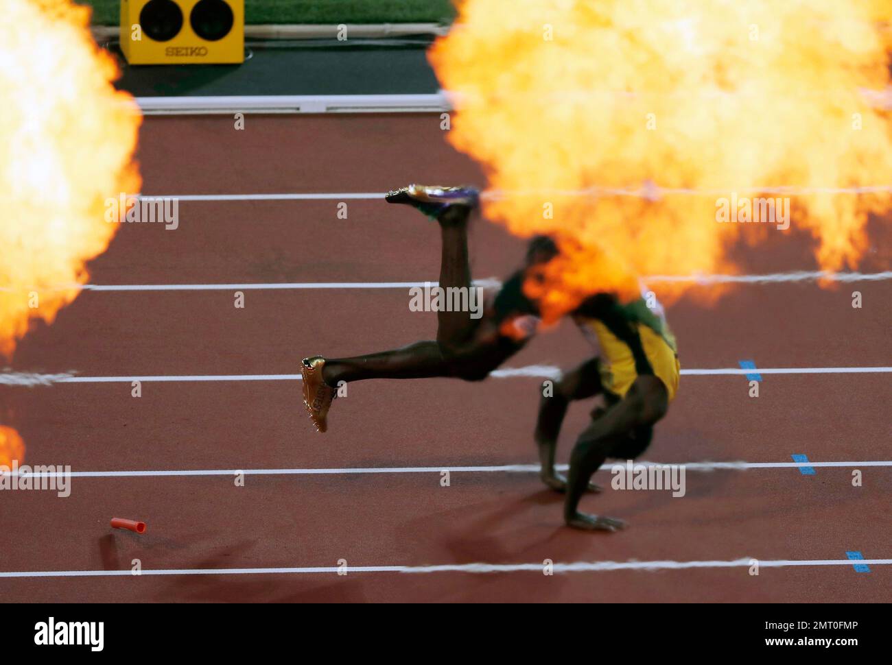 Fireworks for the winner goes off as Jamaica's Usain Bolt falls after ...