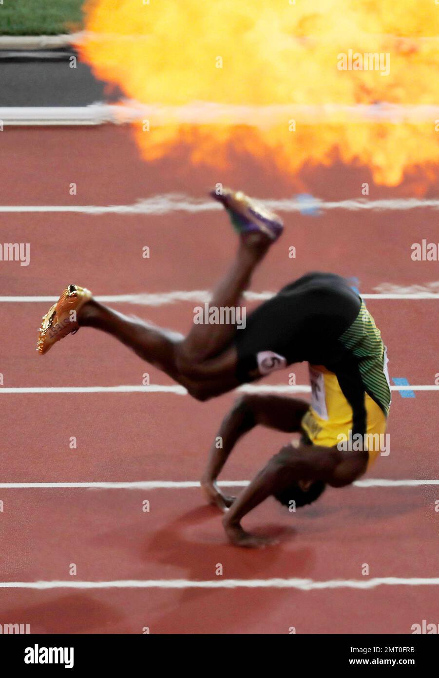 Fireworks for the winner goes off as Jamaica's Usain Bolt falls after ...