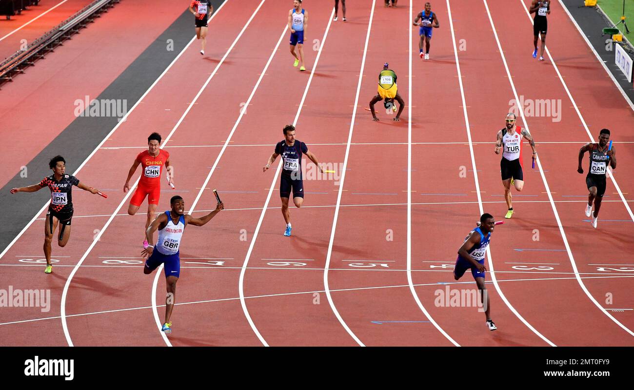Britain's Nathaniel Mitchell-Blake, third left, crosses the finish line ...