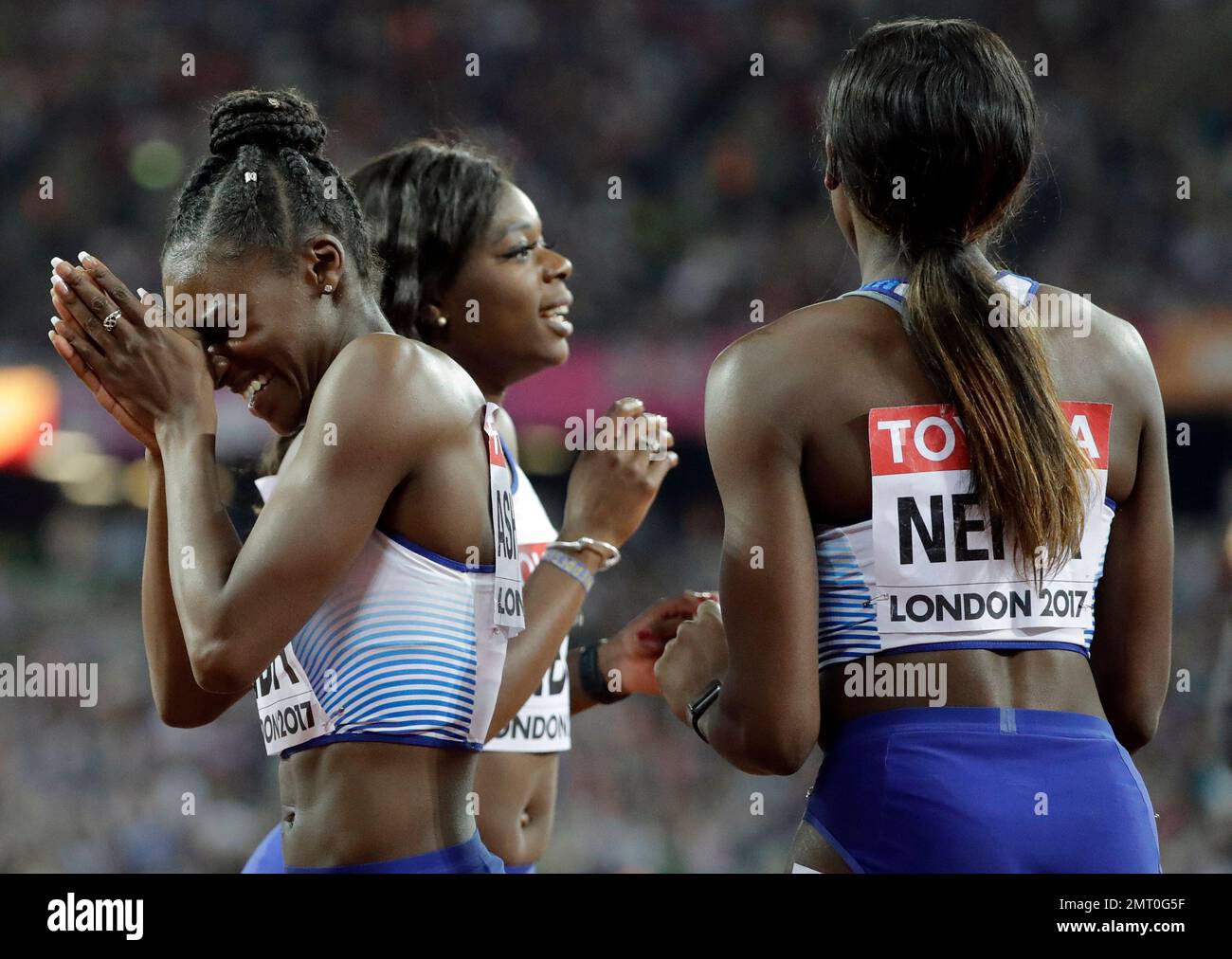 Britain's Dina Asher-Smith, left, celebrates winning the silver in the ...