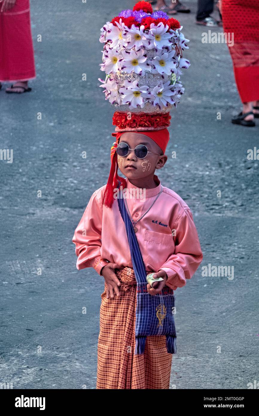 Mon boy in traditional dress during the morning alms ceremnoy in ...