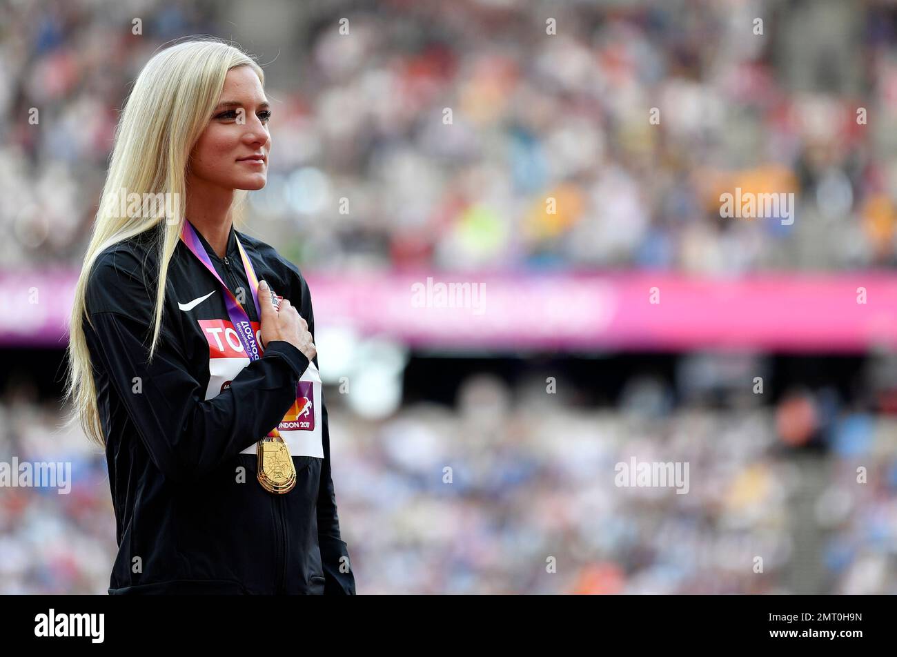 United States' gold medal winner Emma Coburn listens to the national ...