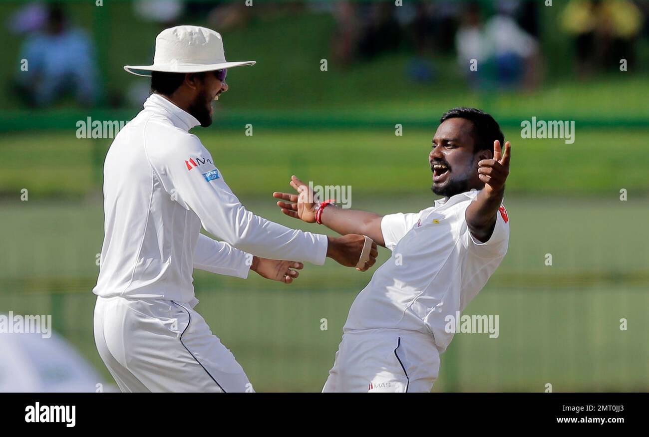 Sri Lanka's Malinda Pushpakumara, right, celebrates with captain Dinesh ...