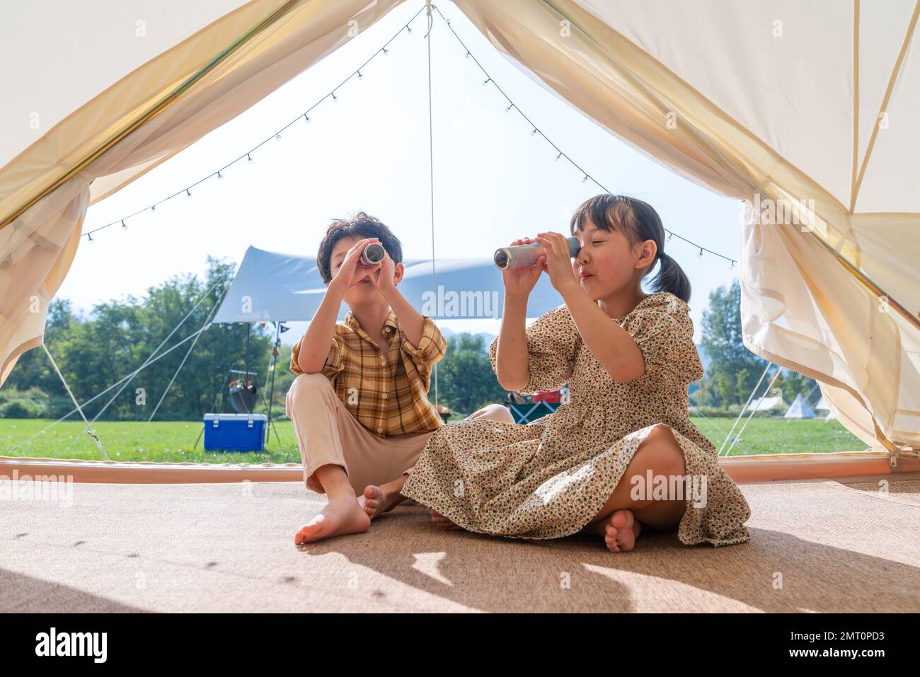 Playing two children sat in the tent Stock Photo - Alamy