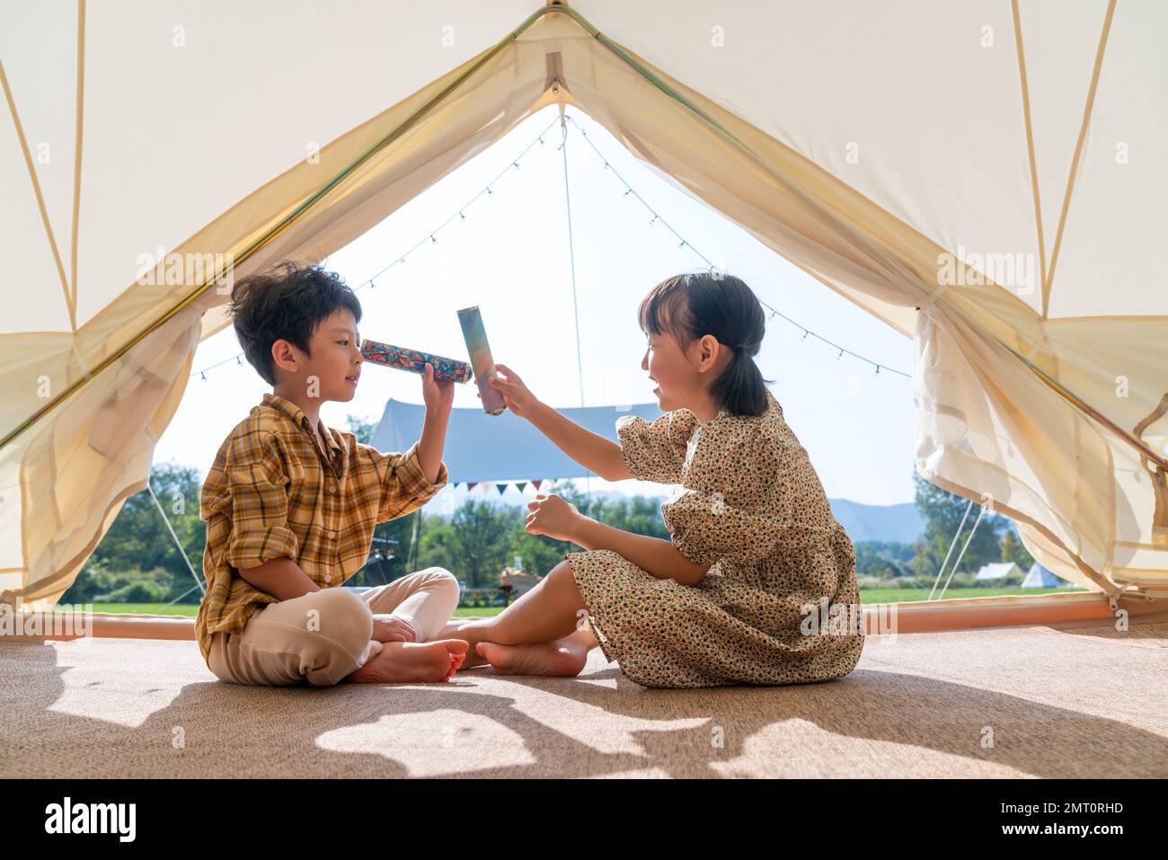 Playing two children sat in the tent Stock Photo - Alamy