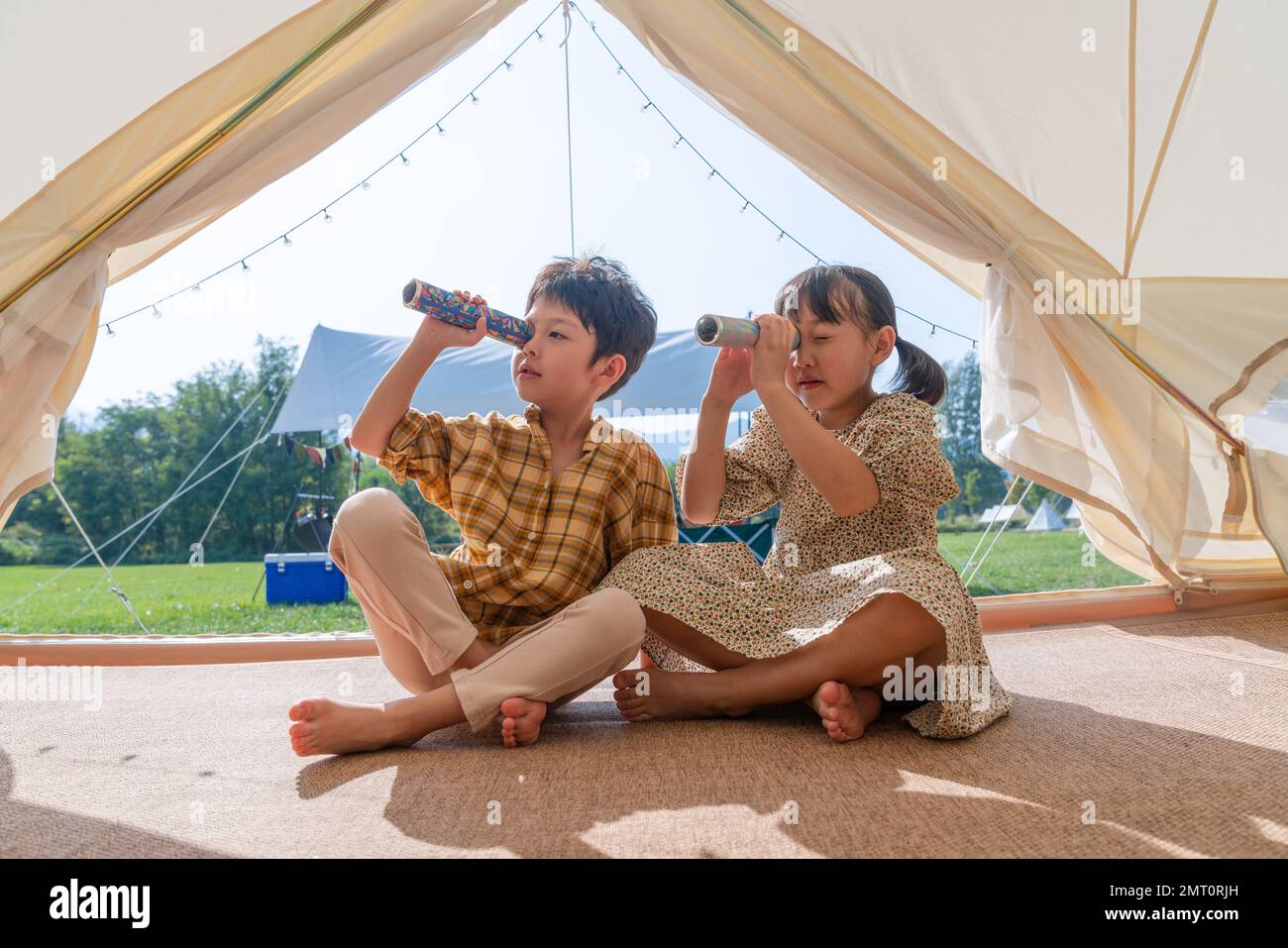Playing two children sat in the tent Stock Photo - Alamy