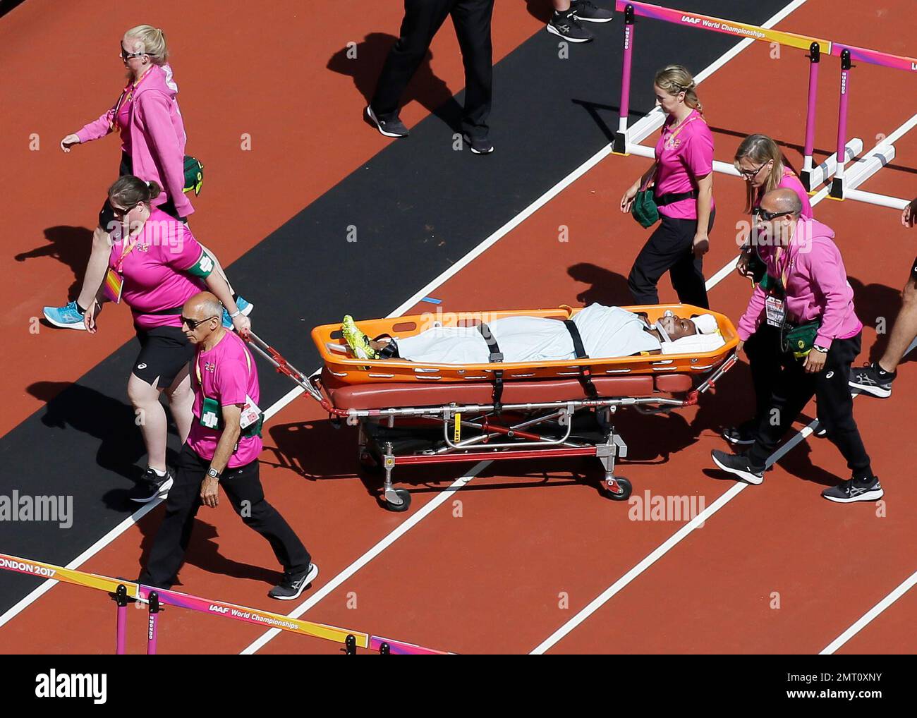 Trinidad and Tobago's Deborah John is stretchered off the track after ...