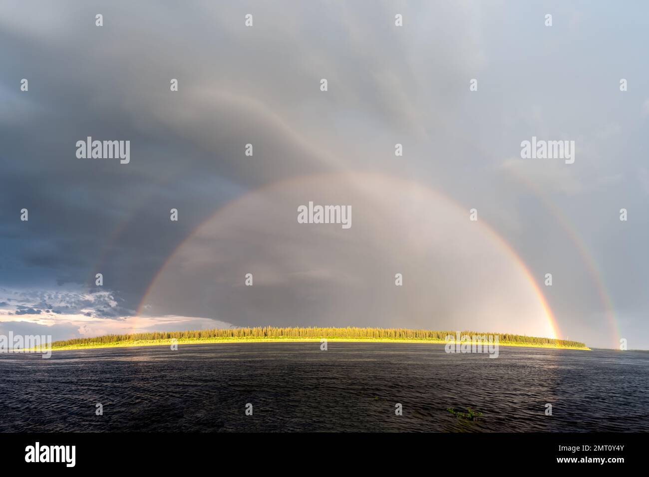 Panorama of a bright double rainbow over the Vilyui River after rain ...