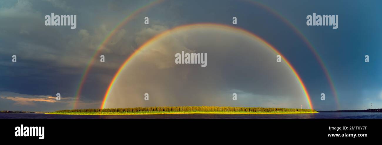 Panorama of a bright double rainbow over the Vilyui River after rain ...