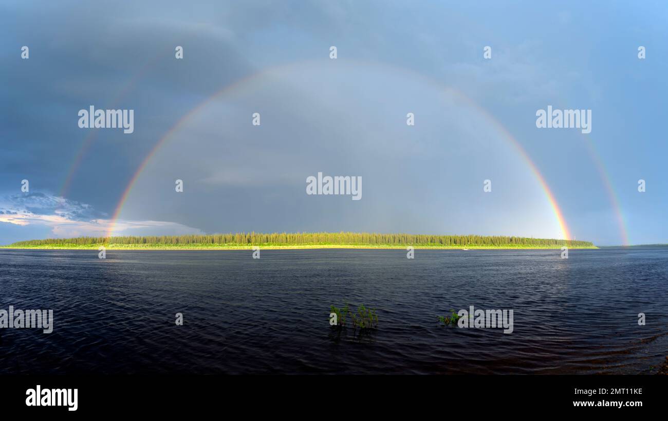 Panorama of a bright double rainbow over the Vilyui River after rain ...