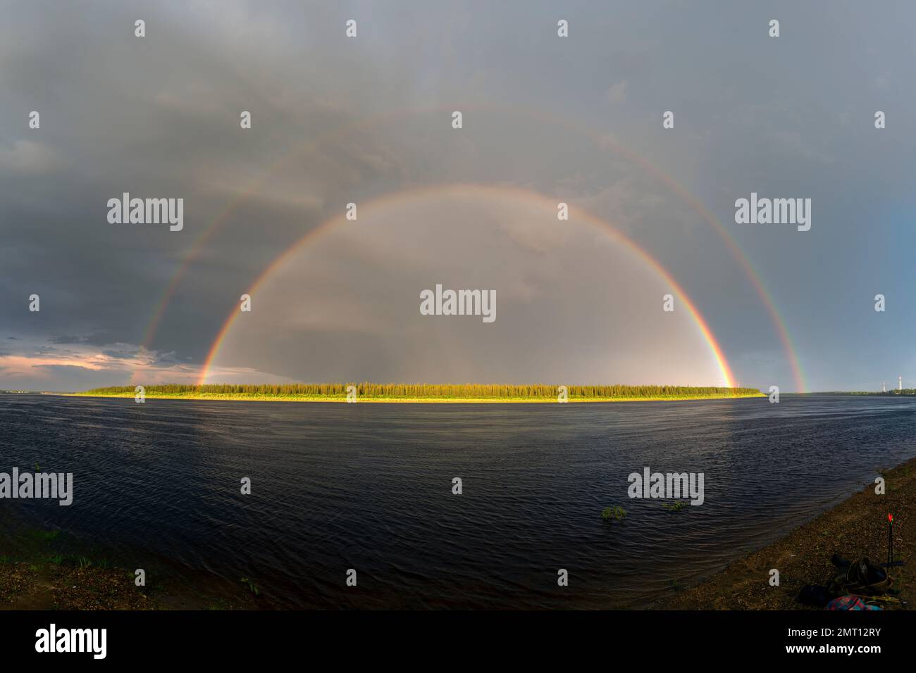 Double rainbow panorama over the Vilyui River after rain against a blue ...