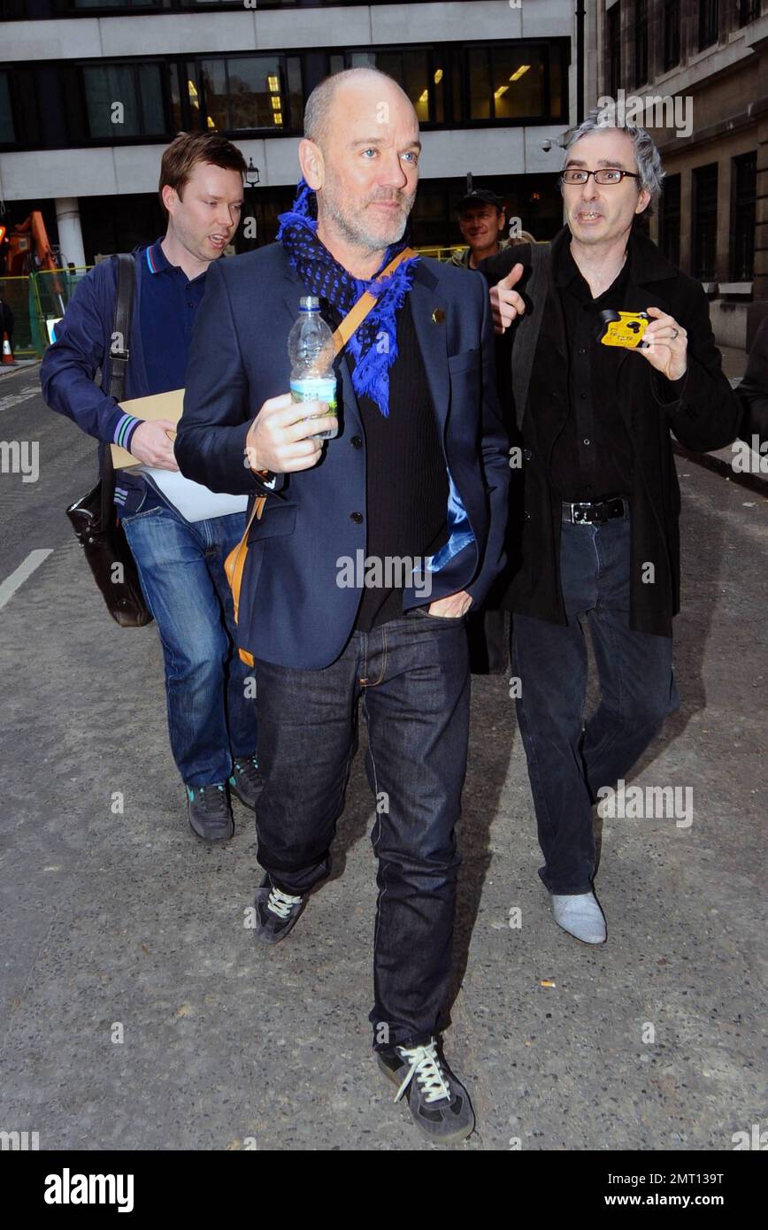 R.E.M. frontman Michael Stipe poses for photos with fans as he arrives ...