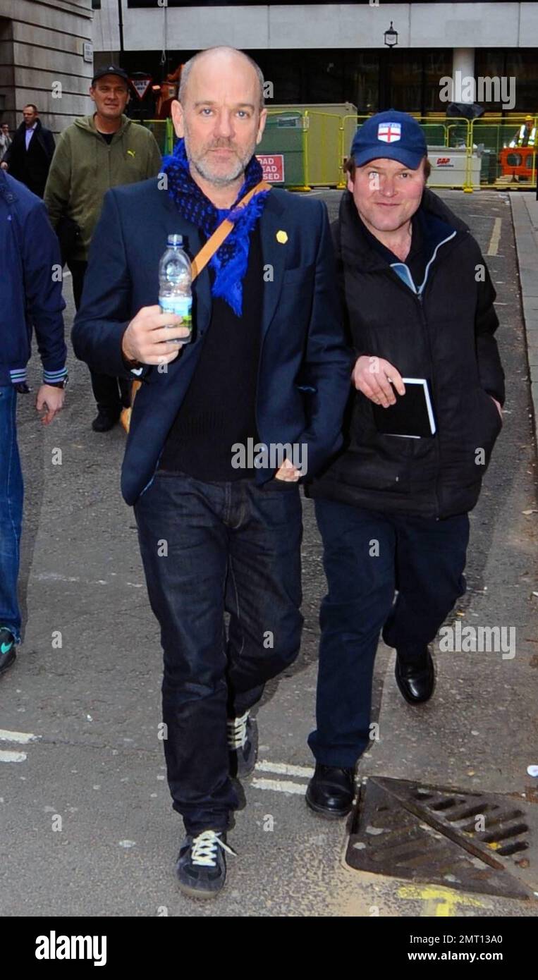 R.E.M. frontman Michael Stipe poses for photos with fans as he arrives ...