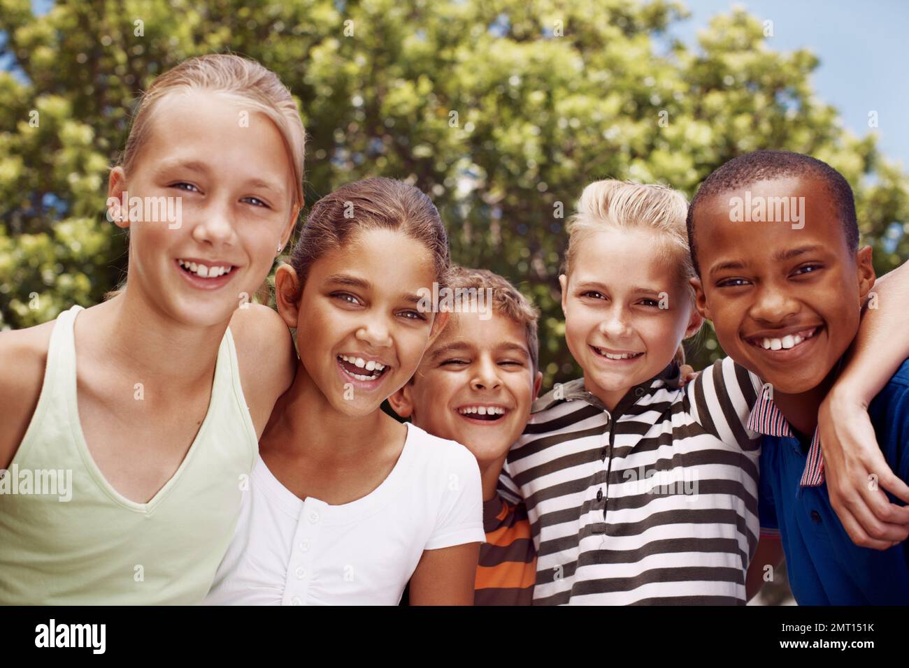 Enjoying their recess together. A group of friends hugging each other ...