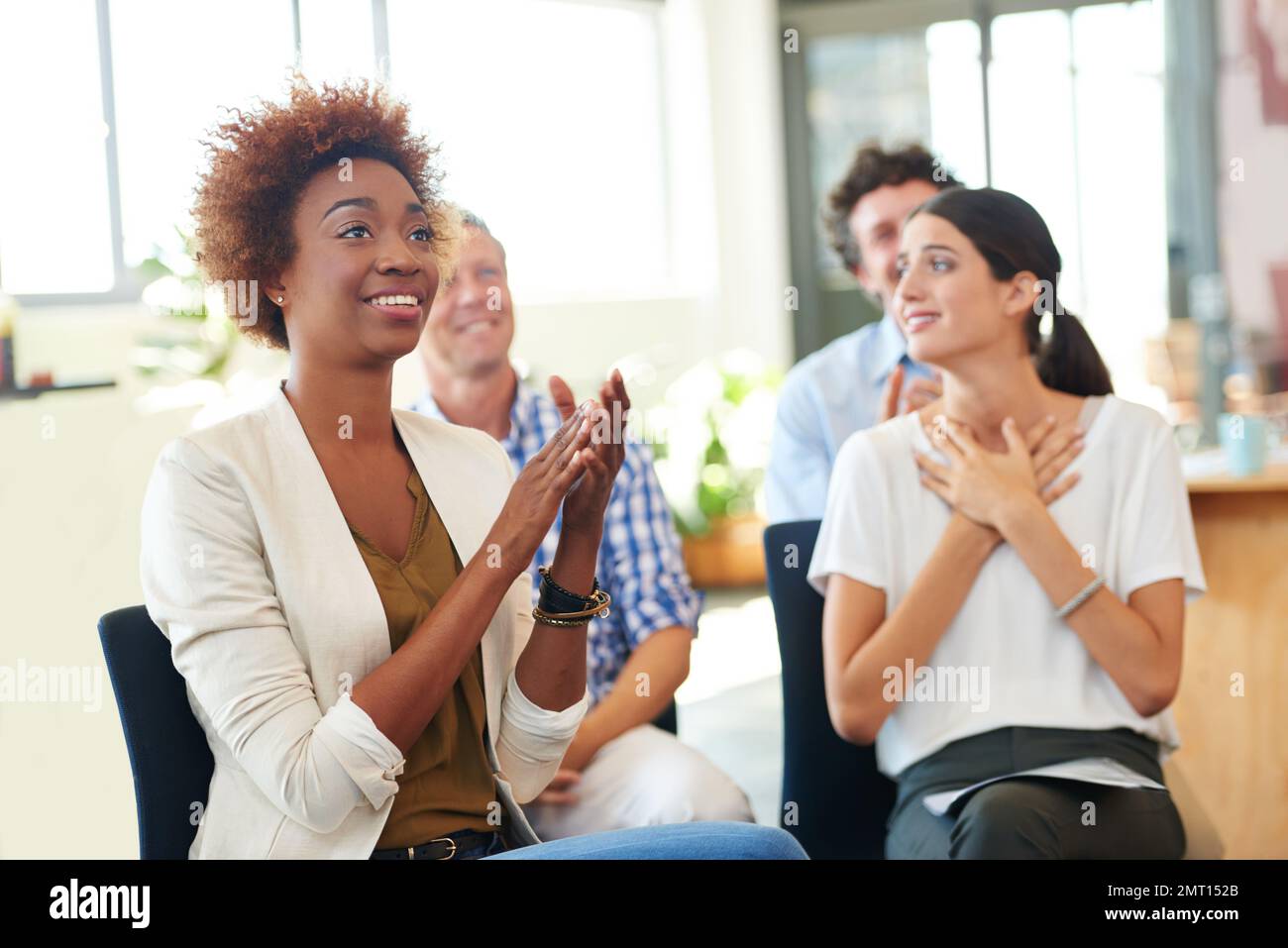 They are impressed. A group of colleagues applauding a work ...
