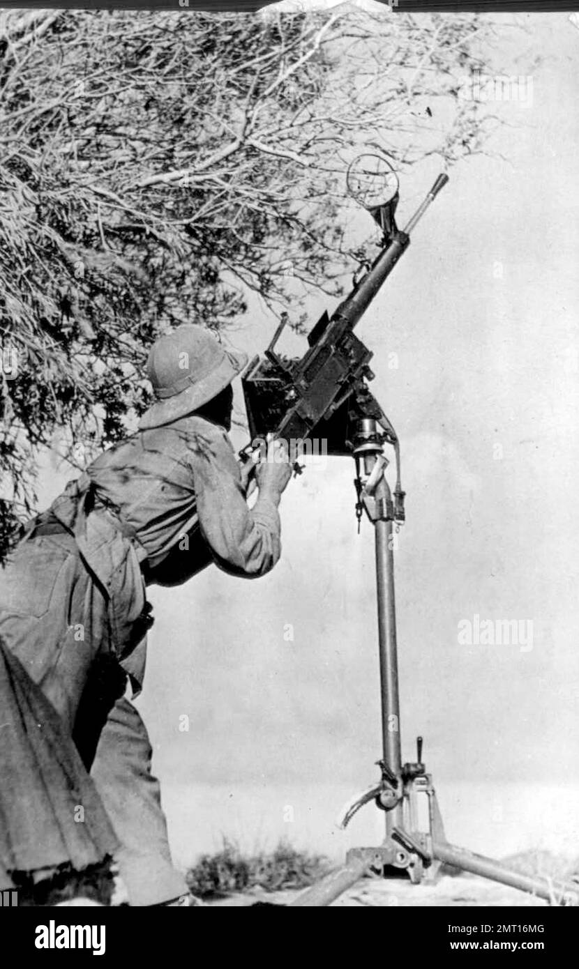 An Italian anti-aircraft gunner is at the ready as he aims for the sky ...