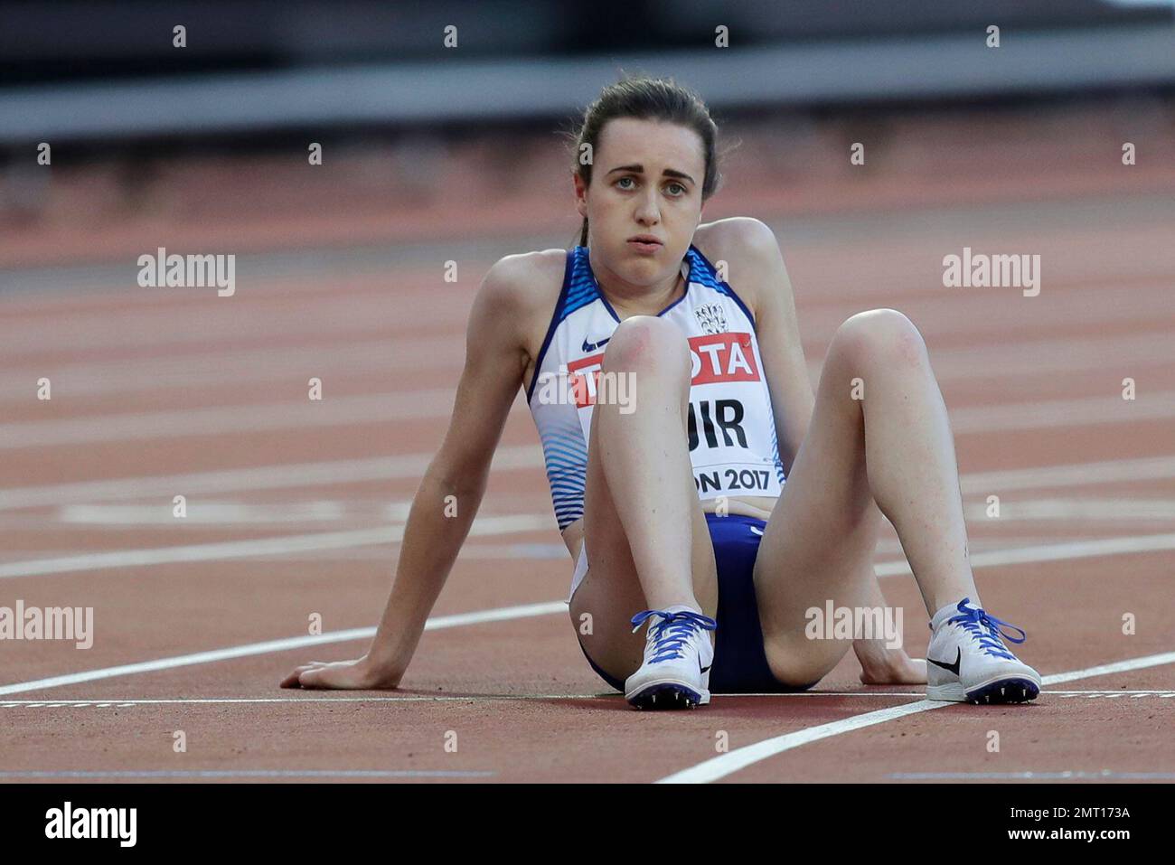 Britain's Laura Muir sits on the track after finishing a Women's 5000m ...