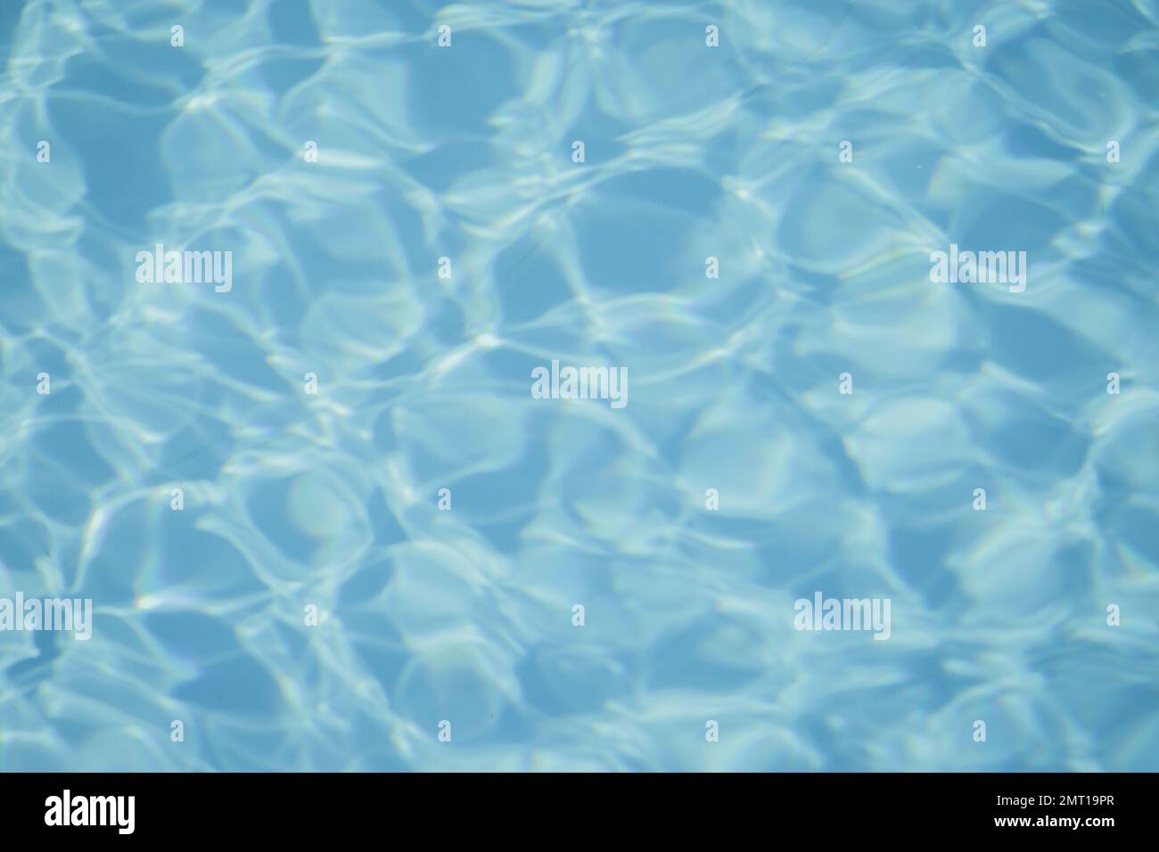 Blue pool water with sun reflections background Stock Photo - Alamy