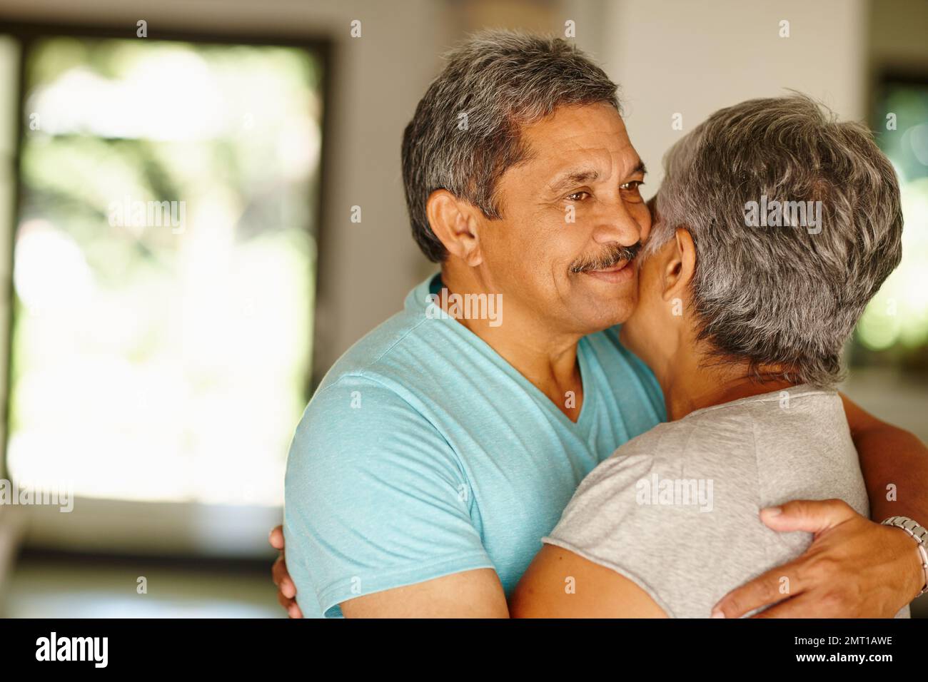 Content with life. Portrait of a mature couple embracing at home Stock ...