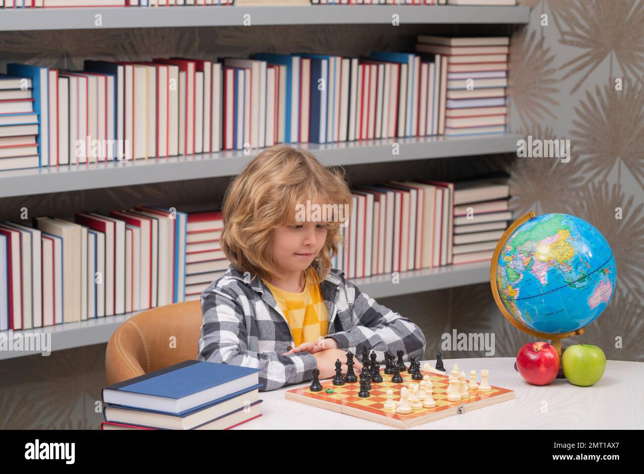 Child play chess in classroom at school. Chess for intelligent kid ...